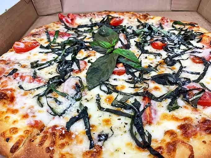 Fresh basil dancing atop melted cheese and bright tomatoes – their margherita pizza proves sometimes the simplest combinations create the most profound flavors.