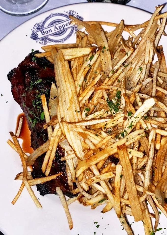 The legendary Steak Frites arrives like a work of art &ndash; perfectly seared beef alongside golden fries that beg to be dunked in that glorious sauce.