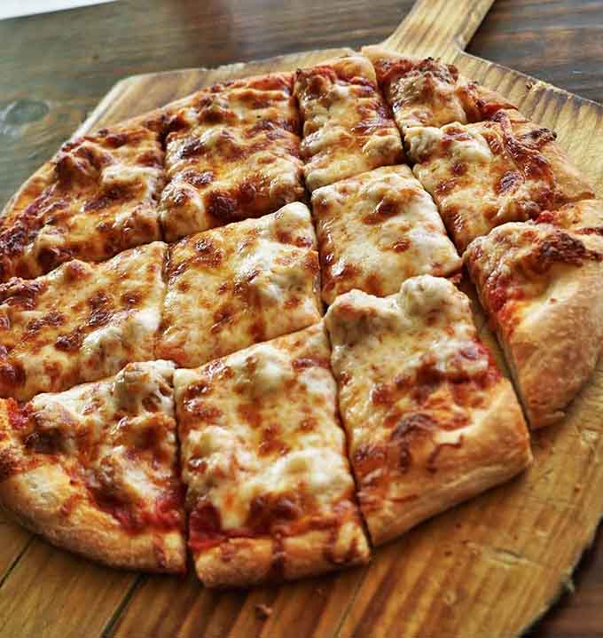 Square-cut sausage pizza that makes you question everything you thought you knew about proper pizza geometry and flavor distribution.