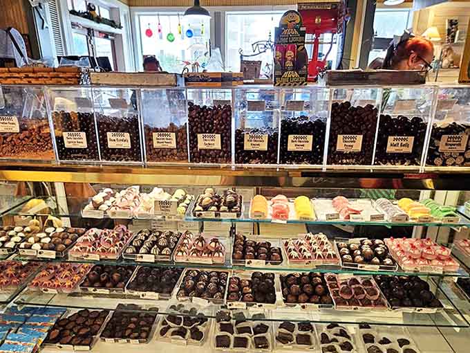 Chocolate paradise awaits behind this glass &ndash; each piece handcrafted with the kind of attention that makes you wonder if eating them is actually art theft.