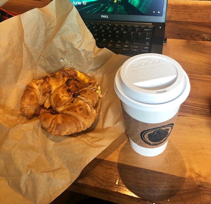 A flaky croissant breakfast sandwich paired with hot coffee is the kind of morning power couple that makes everything else seem possible.