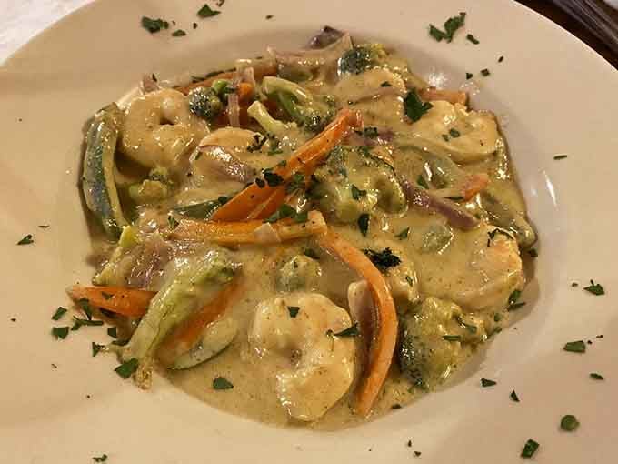 Thai green curry arrives looking like liquid emerald, vegetables swimming in coconut-rich sauce that'll transport you straight to Southeast Asia.