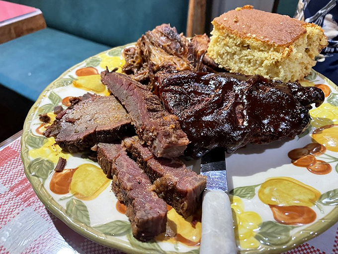 Behold the carnivore's dream team! Brisket, ribs, and cornbread playing together in perfect harmony on this heavenly plate.