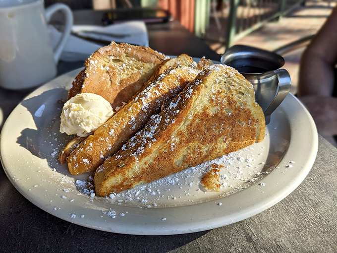 French toast that deserves its own passport! Golden, crispy exterior giving way to a custardy center that'll make you forget all other breakfast options.