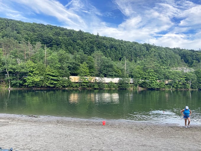 History meets nature: A vintage train passes the park's edge, offering passengers a fleeting glimpse of Vermont's hidden paradise.