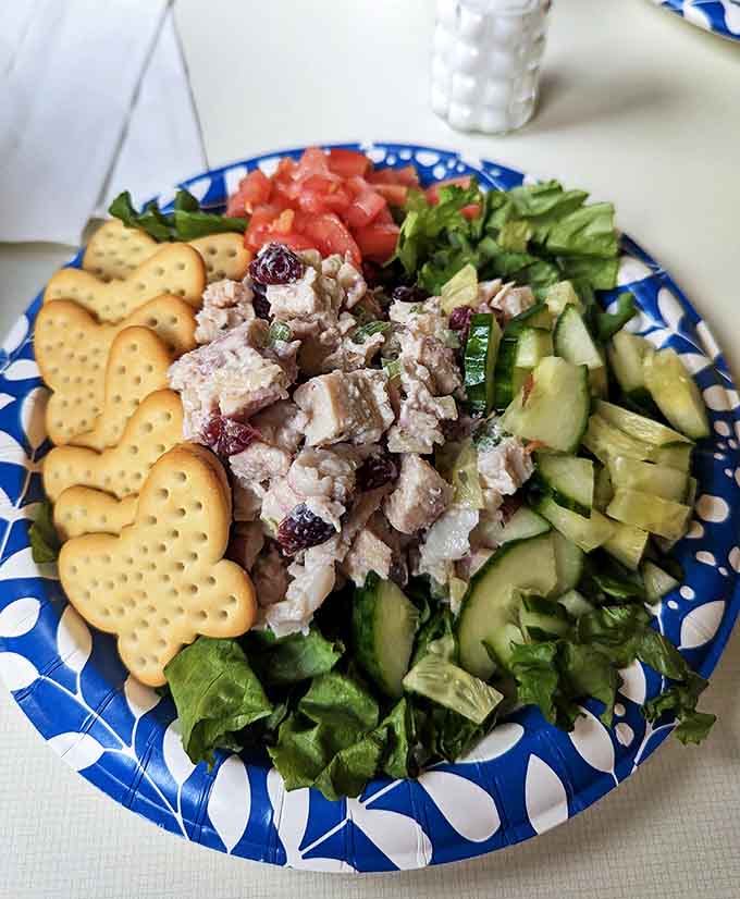 A colorful arrangement of homestyle tuna salad surrounded by fresh vegetables and buttery crackers. Comfort food that doesn't need to shout to make its point.