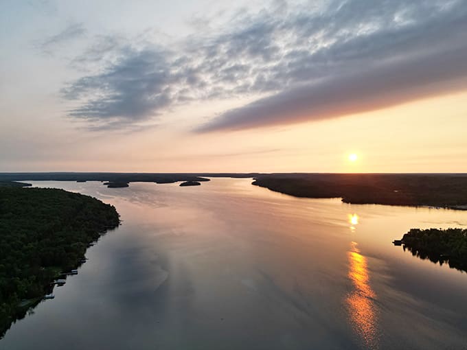 Golden hour transforms Lake Michigamme into liquid amber, with silhouetted islands creating a scene worthy of framing.