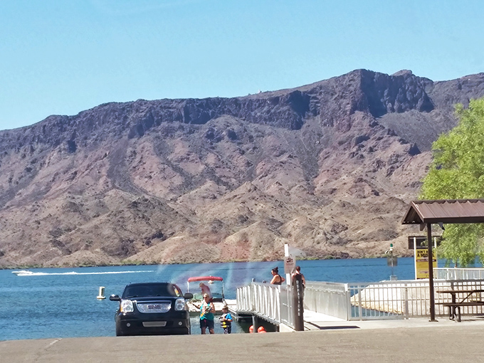 Families find their perfect spot along the shoreline, where the gradual entry into the lake makes it ideal for swimmers of all ages.