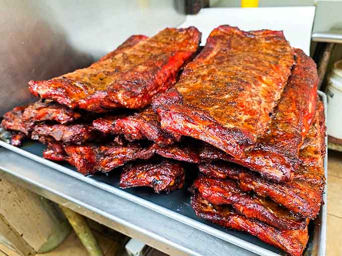 These ribs have spent more time in the smoker than most people spend planning their vacations, and it shows in every bite.