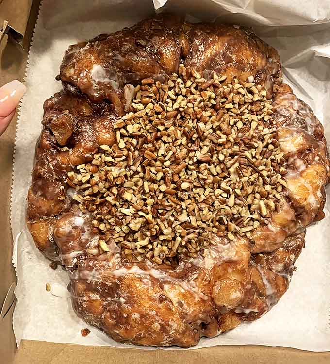 This isn't just an apple fritter&mdash;it's a monument to donut perfection. The massive, glazed creation topped with nuts could easily be breakfast for two.