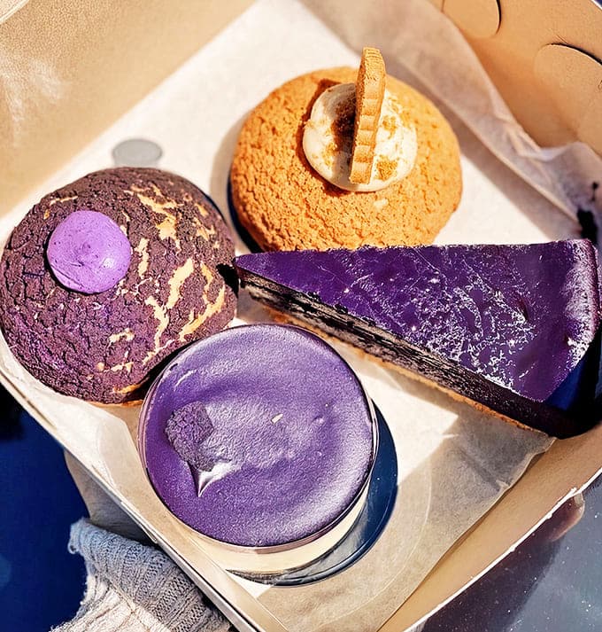Dessert indecision never looked so good &ndash; a box of treats featuring the bakery's signature purple creations alongside classic favorites.