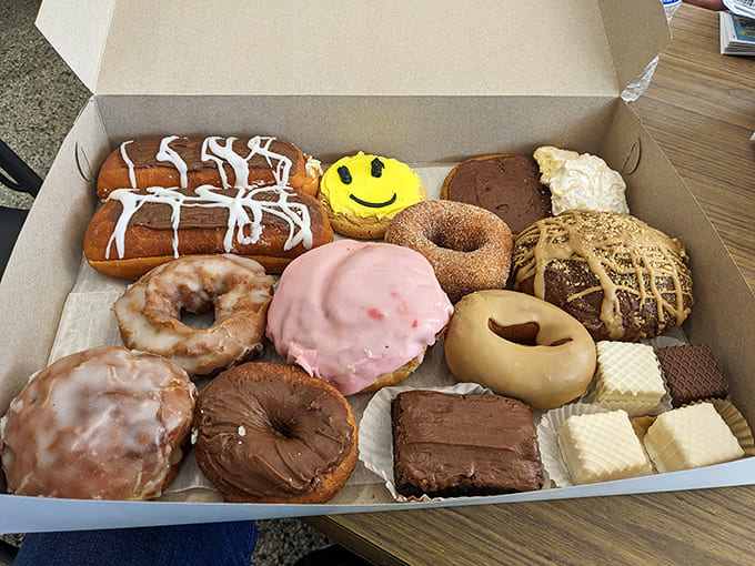 Decisions, decisions! A box of Van's assorted donuts presents the sweetest dilemma you'll face all day &ndash; the smiley face cookie seems particularly pleased with your predicament.