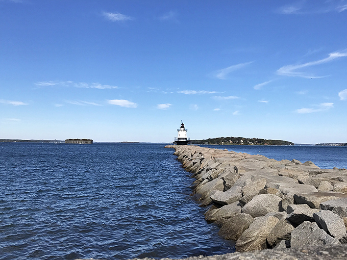 Walking the granite breakwater feels like traversing a giant's game of hopscotch, with each massive stone offering a new foothold.