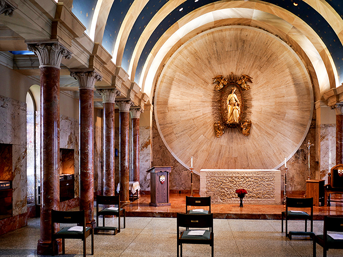 The circular chapel features stunning marble columns surrounding an altar bathed in natural light from above.