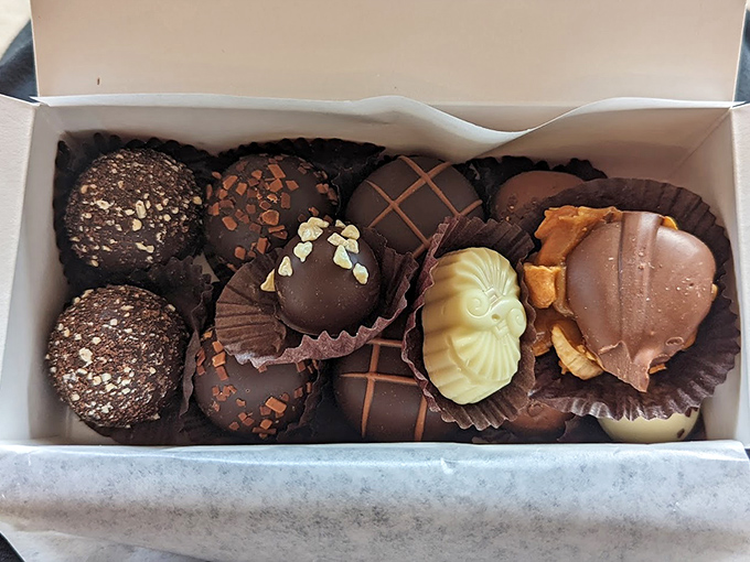 Chocolate heaven exists in these display cases – each piece handcrafted with care that transforms simple ingredients into edible art.