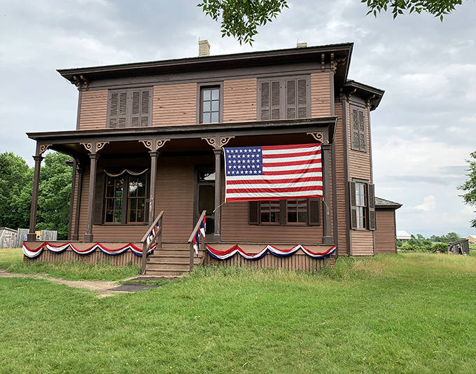 The stately farmhouse stands proudly with its American flag &ndash; a Victorian-era welcome center where history comes alive.
