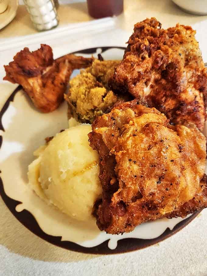 Golden-brown chicken meets cloud-like mashed potatoes in a match made in comfort food heaven. That gravy pool? Pure liquid gold.