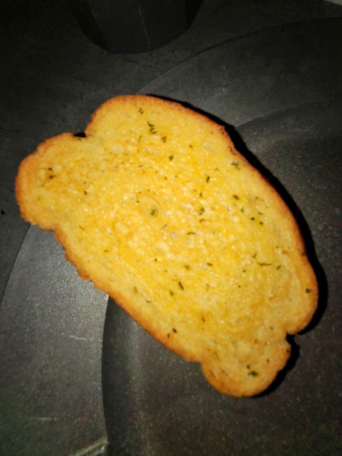 Golden garlic bread, the first course of your medieval feast, arrives with enough butter and herbs to make a peasant weep with joy.