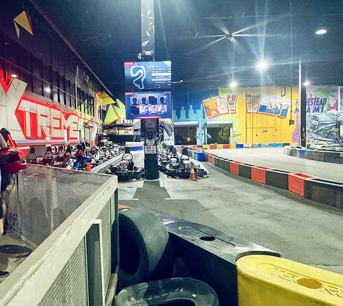 The scoreboard doesn't lie! Teams huddle near their chariots of speed, plotting strategies and forming unlikely alliances before the next adrenaline-fueled heat.