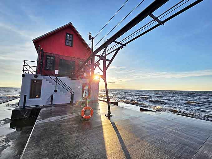Dawn breaks over Lake Michigan, casting the lighthouse in golden light while the pier creates leading lines into the horizon.