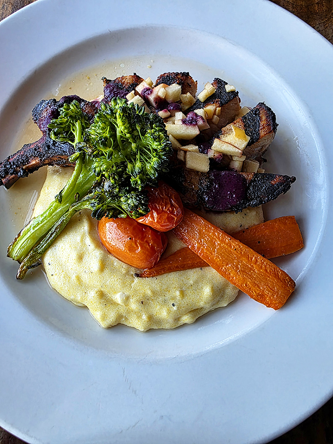 This grilled pork chop with creamy polenta and seasonal vegetables showcases the kitchen's philosophy: simple ingredients transformed through perfect technique.