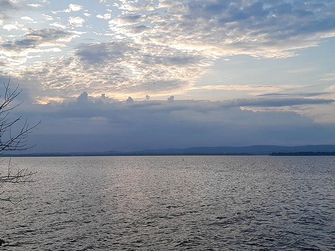 The view across the water toward distant mountains makes you wonder why anyone bothers with ocean beaches when lakes can look this majestic.