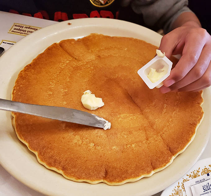 Golden perfection spanning the entire plate &ndash; that first pat of butter creating a melting pool of breakfast bliss.