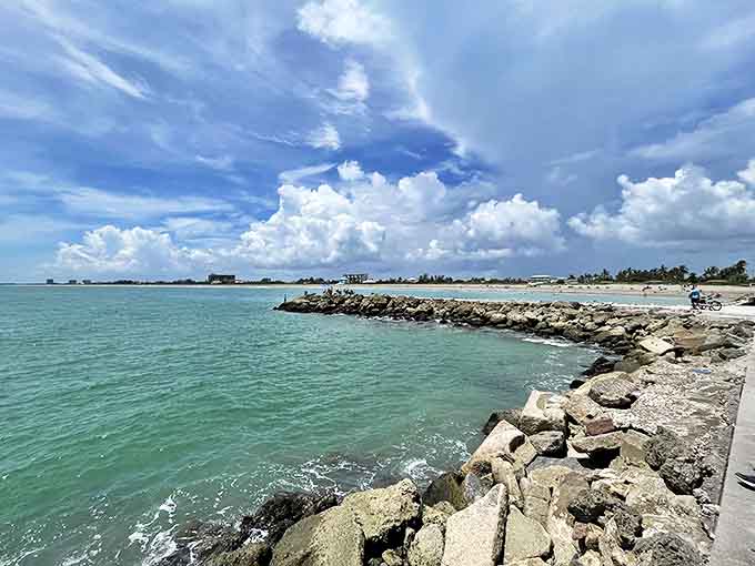 Massive boulders form a natural breakwater, their weathered surfaces telling silent stories of countless tides and storms.