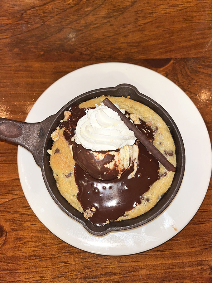Warm skillet cookie meets cold ice cream in a dessert showdown where everybody wins. The melting vanilla creates rivers of sweetness through chocolate chip terrain.
