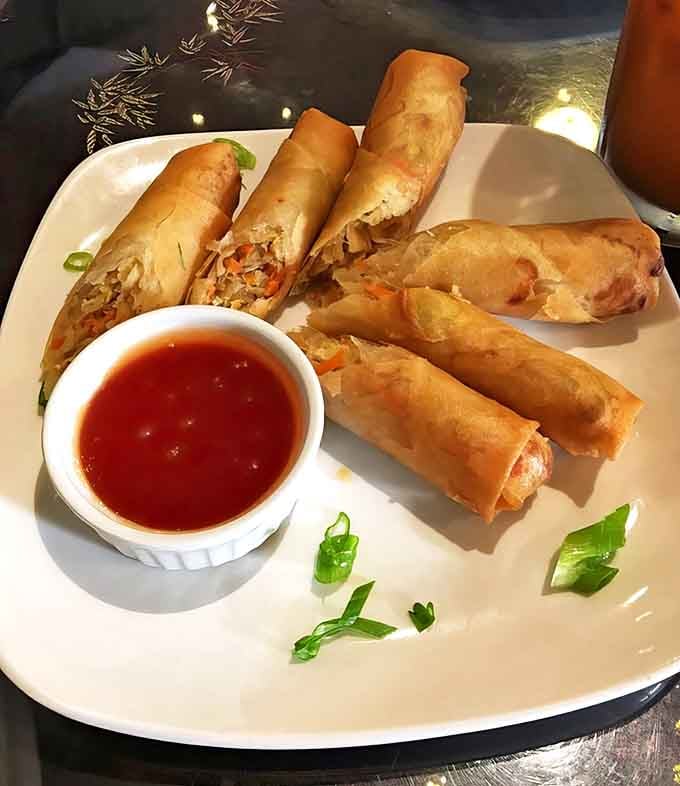 These spring rolls crack with perfect precision, revealing a treasure of fresh fillings inside. The dipping sauce? Worth bottling and selling by the gallon!
