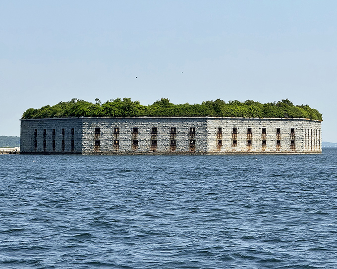 The massive granite fortress rises from the water like a stone island, its windows watching over Portland Harbor as they have for generations.