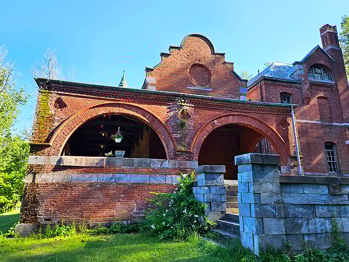 The arched stonework and brick details prove that Victorian builders understood the assignment when it came to making functional elements look absolutely spectacular.