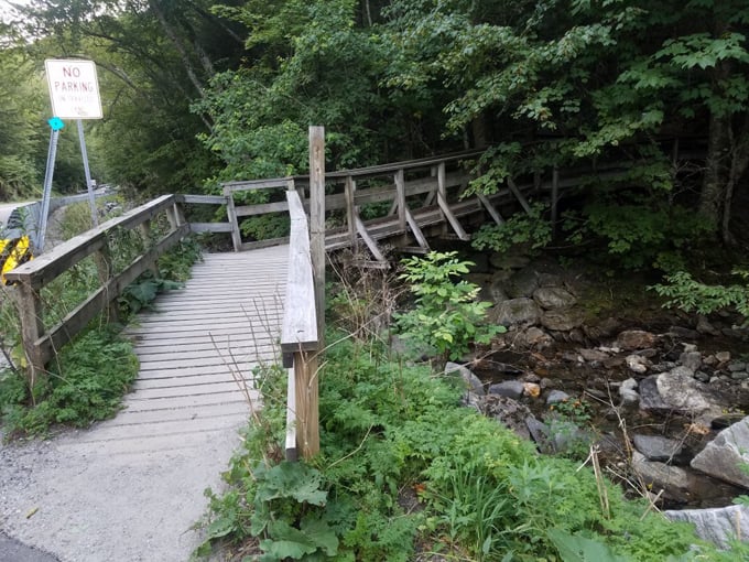 This rustic wooden bridge isn't just functional &ndash; it's the gateway to Vermont's most photogenic water feature.