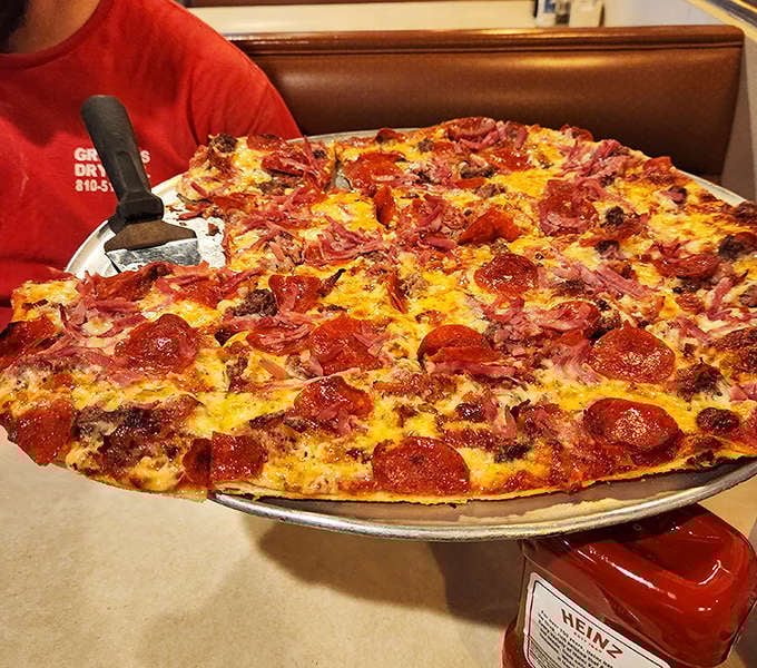 This meat lover's dream features perfectly curled pepperoni creating tiny flavor cups atop a blanket of melted cheese.