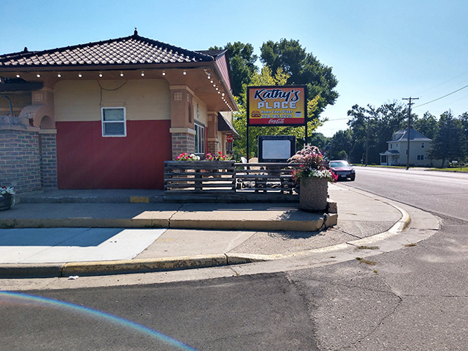 Kathy's Place in Sacred Heart features a welcoming exterior with colorful flowers, promising homestyle cooking in a friendly small-town setting.