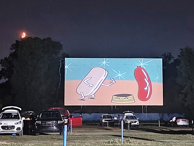Cars gather under twilight skies at US 23 Drive-In, where double features turn ordinary evenings into memorable movie marathons.