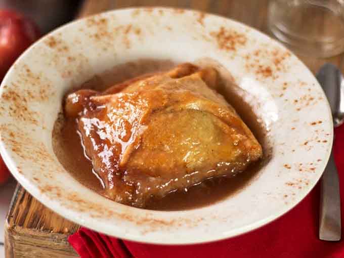 Golden pastry cradles cinnamon-spiced apple in a warm caramel bath &ndash; this isn't just dessert, it's edible nostalgia that's worth the drive.