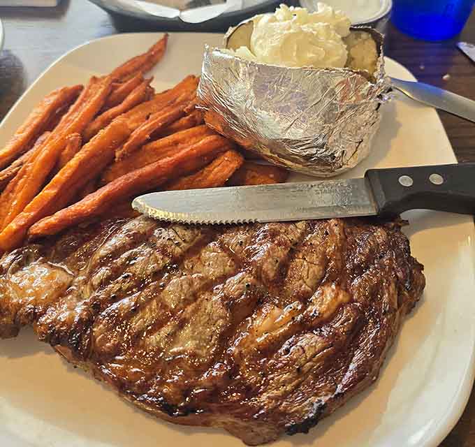 A beautifully grilled steak paired with those famous sweet potato fries creates a plate worthy of your finest food photography.