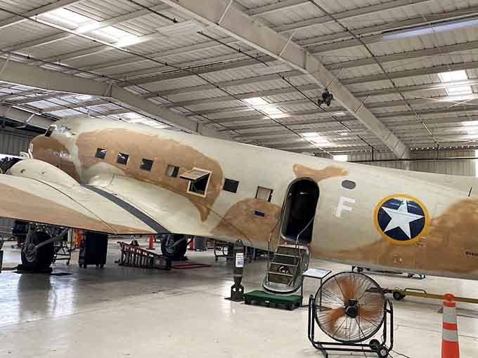 The C-47 Skytrain wears its desert camouflage like a badge of honor from countless missions over hostile territory.