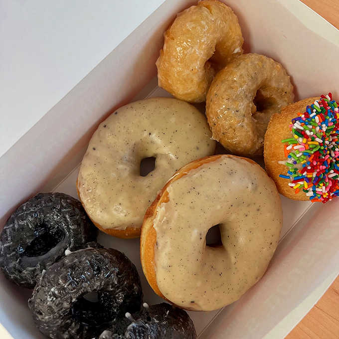 A box of joy! Chocolate-glazed, sprinkled, and those signature brown butter beauties—choosing just one might be the hardest decision of your day.