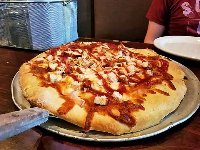 BBQ chicken pizza that makes you question your loyalty to traditional toppings – sweet, tangy sauce perfectly balanced with smoky chicken and melted cheese.