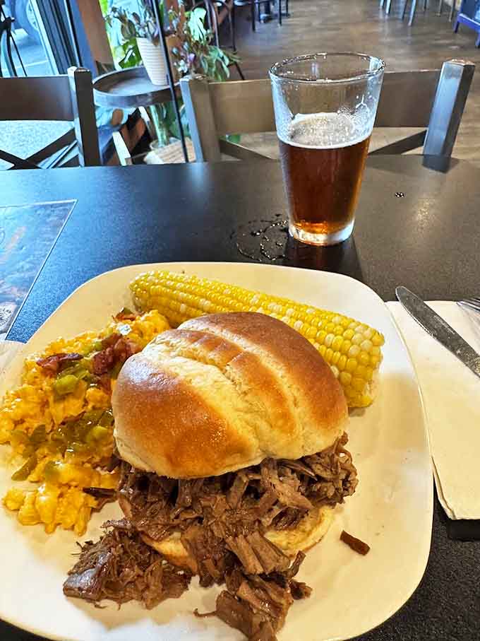 That pulled pork sandwich is piled so high it defies structural engineering, requiring both hands and possibly a strategic eating plan.