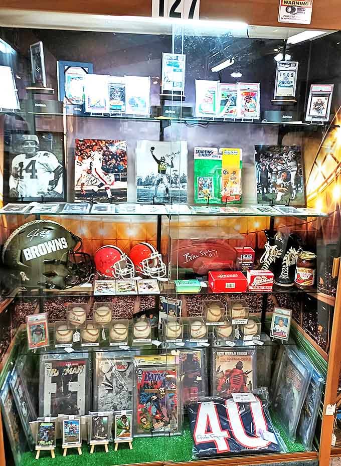 Cleveland sports history lives in these glass cases, where signed memorabilia and trading cards preserve moments of athletic glory.