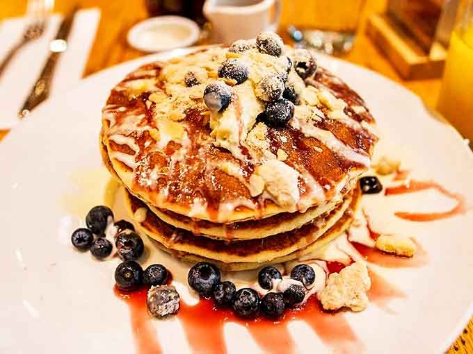 Blueberry pancakes stacked three high with fresh berries and a dusting of powdered sugar &ndash; proof that sometimes food really can look as good as it tastes.