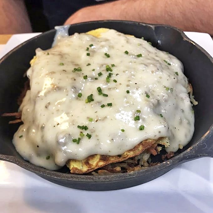 This breakfast skillet looks like someone took everything good about morning and piled it into one pan, then covered it with enough gravy to make angels weep.