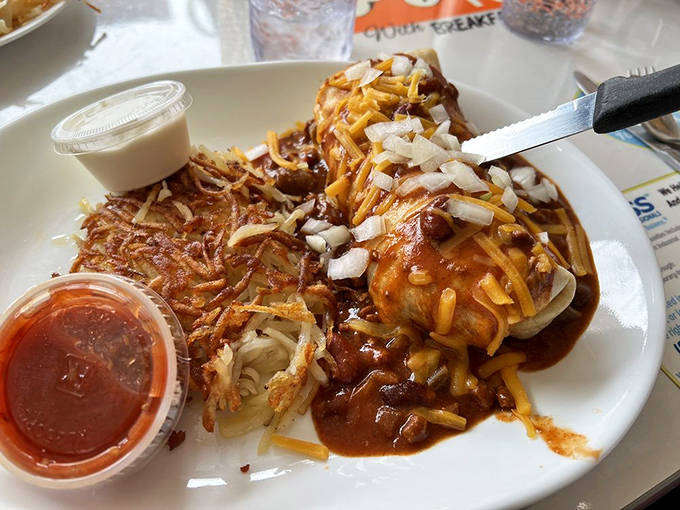 This isn't just a breakfast burrito &ndash; it's a hand-held flavor fiesta smothered in chili, cheese, and enough onions to make your taste buds dance.