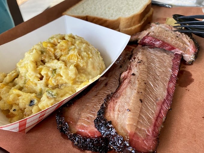 A perfect marriage: fork-tender brisket with that coveted smoke ring alongside the creamy corn casserole that's worth the trip alone.