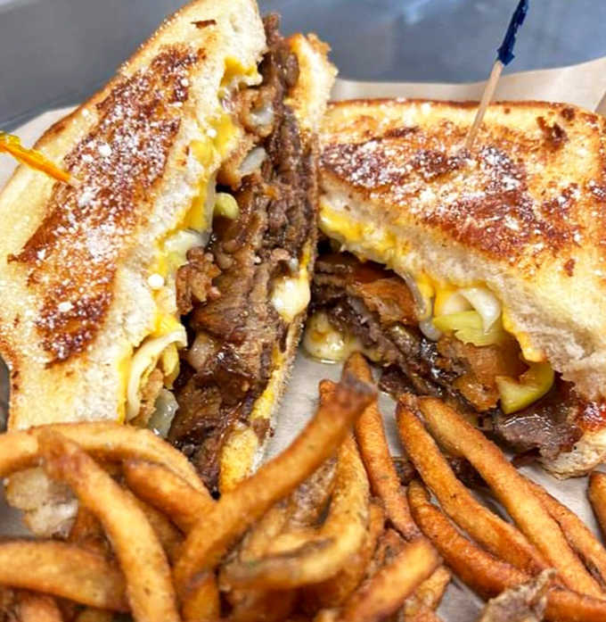 Comfort food squared – smoky brisket meets creamy mac and cheese between grilled bread for an indulgent handheld miracle.