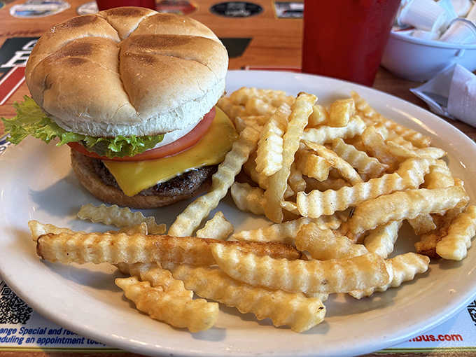 This isn't just any burger &ndash; it's diner alchemy at work, with a perfectly melted cheese slice, fresh toppings, and crinkle-cut fries that crunch with each satisfying bite.