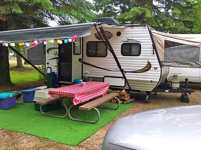 This camper setup looks more inviting than some hotel rooms, complete with festive lights that say "vacation mode activated."
